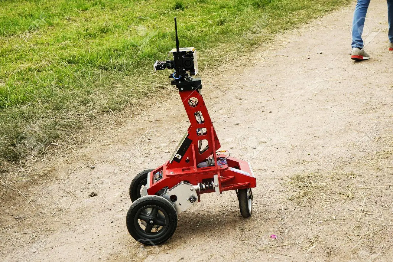 84246658-red-metal-robot-with-3-wheels-machine-stays-on-a-ground-head ...